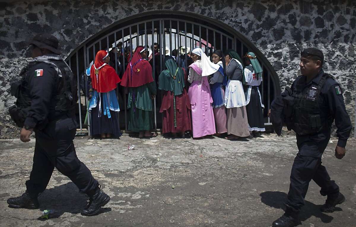 Followers of the Virgen del Rosario religious group fight for secular ...