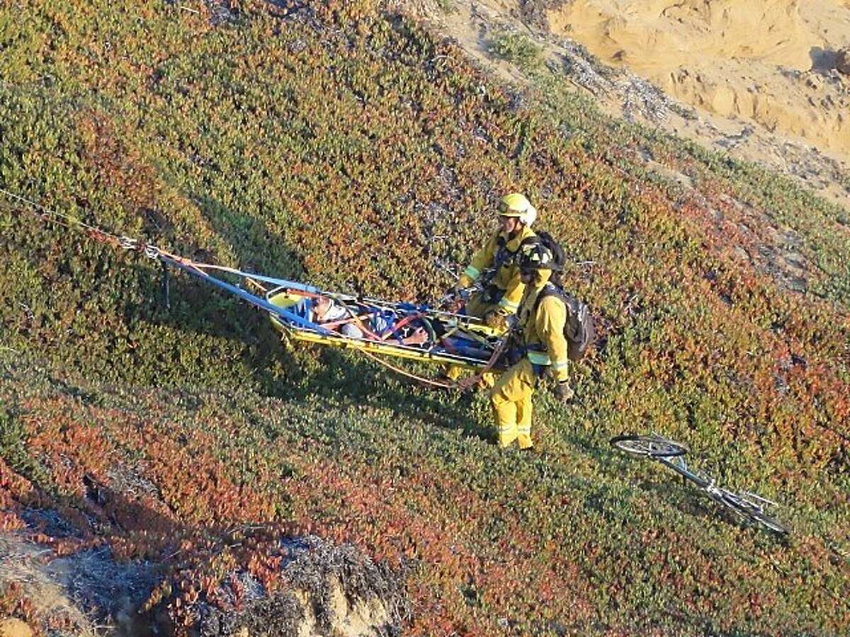 Cyclist rescued after falling off cliff