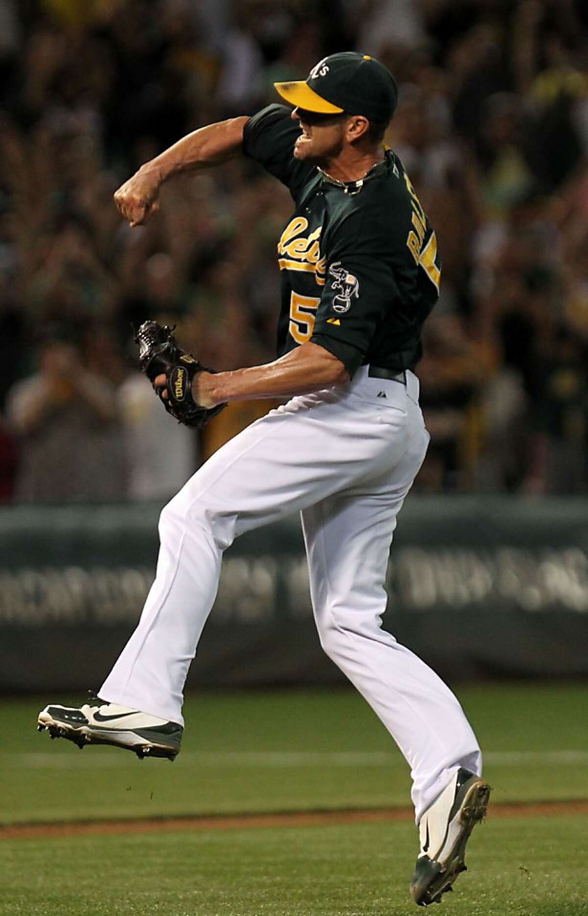 A's beat Rangers, clinch playoff berth