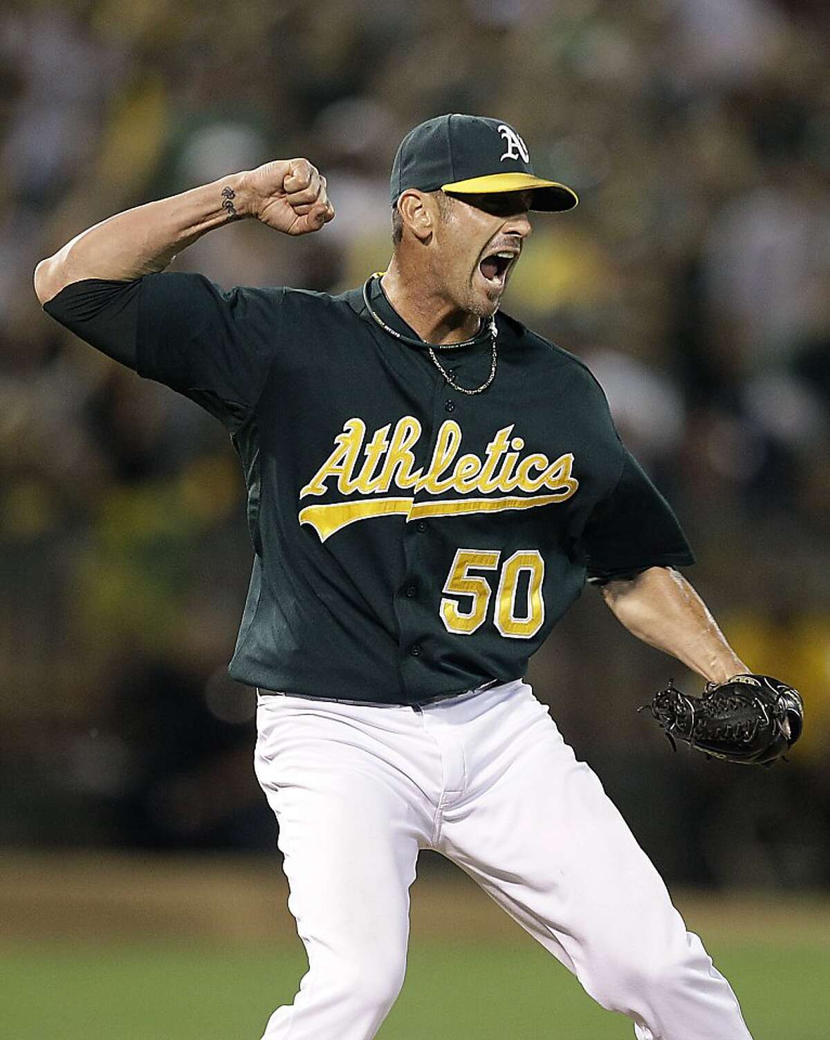 A's beat Rangers, clinch playoff berth