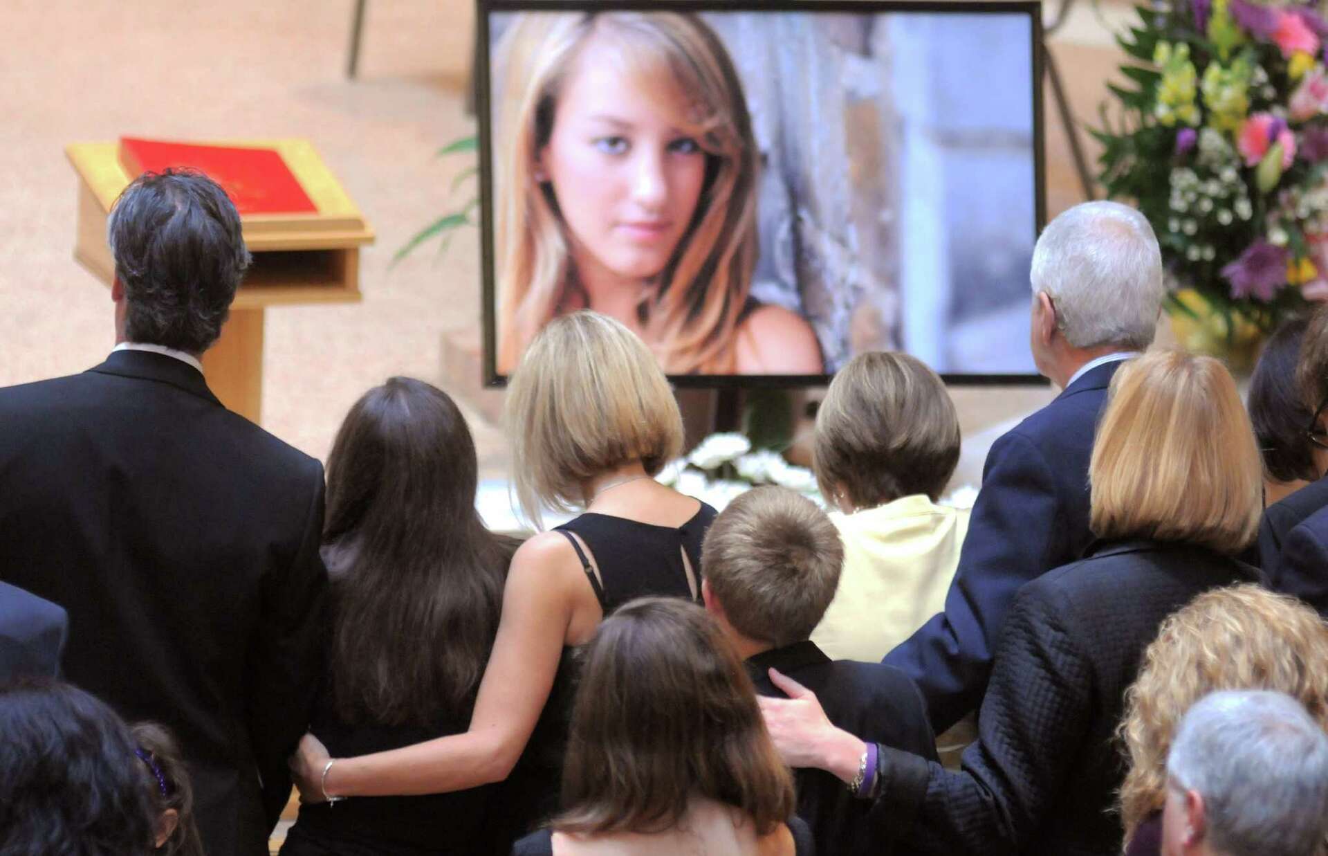 Mourners don purple at beaten student's funeral