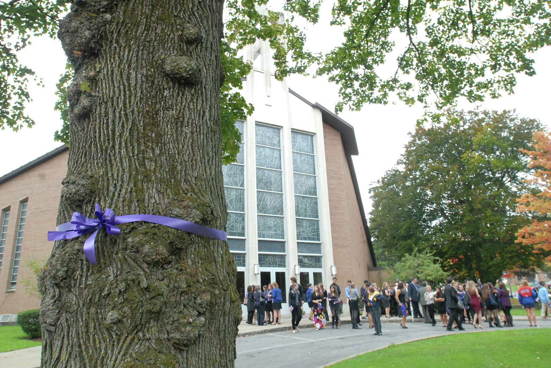 Mourners don purple at beaten student's funeral