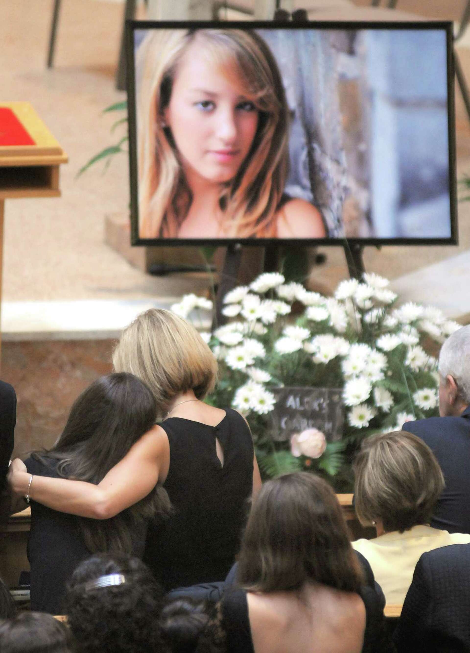 Mourners don purple at beaten student's funeral