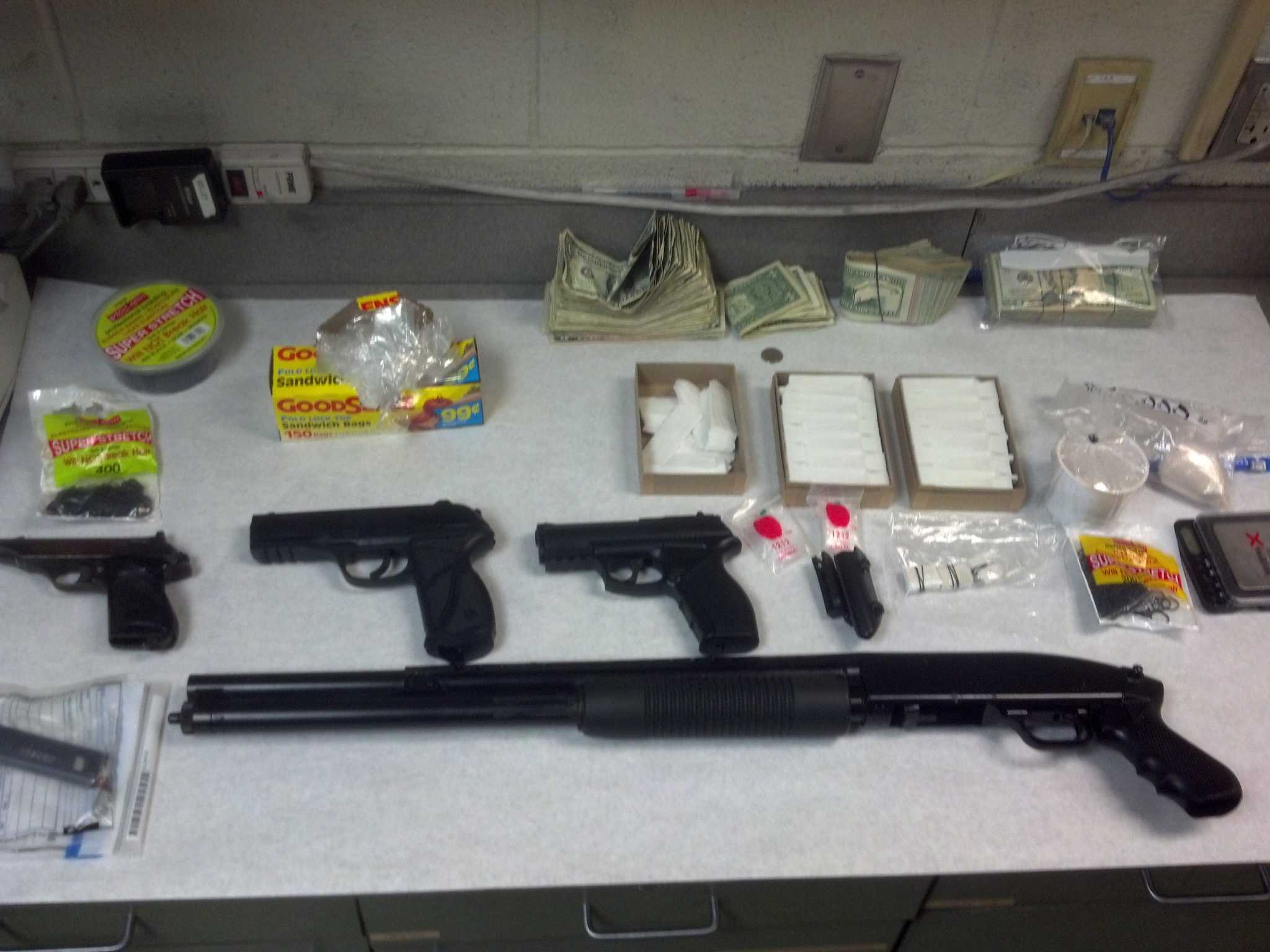 Police: Raid nets heroin, guns and cash