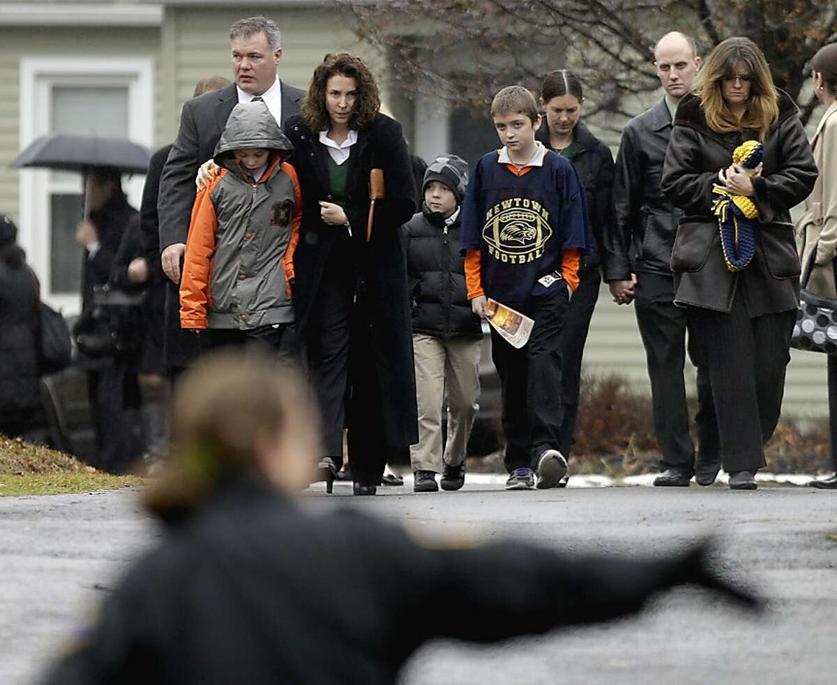 Newtown begins burying its slain children