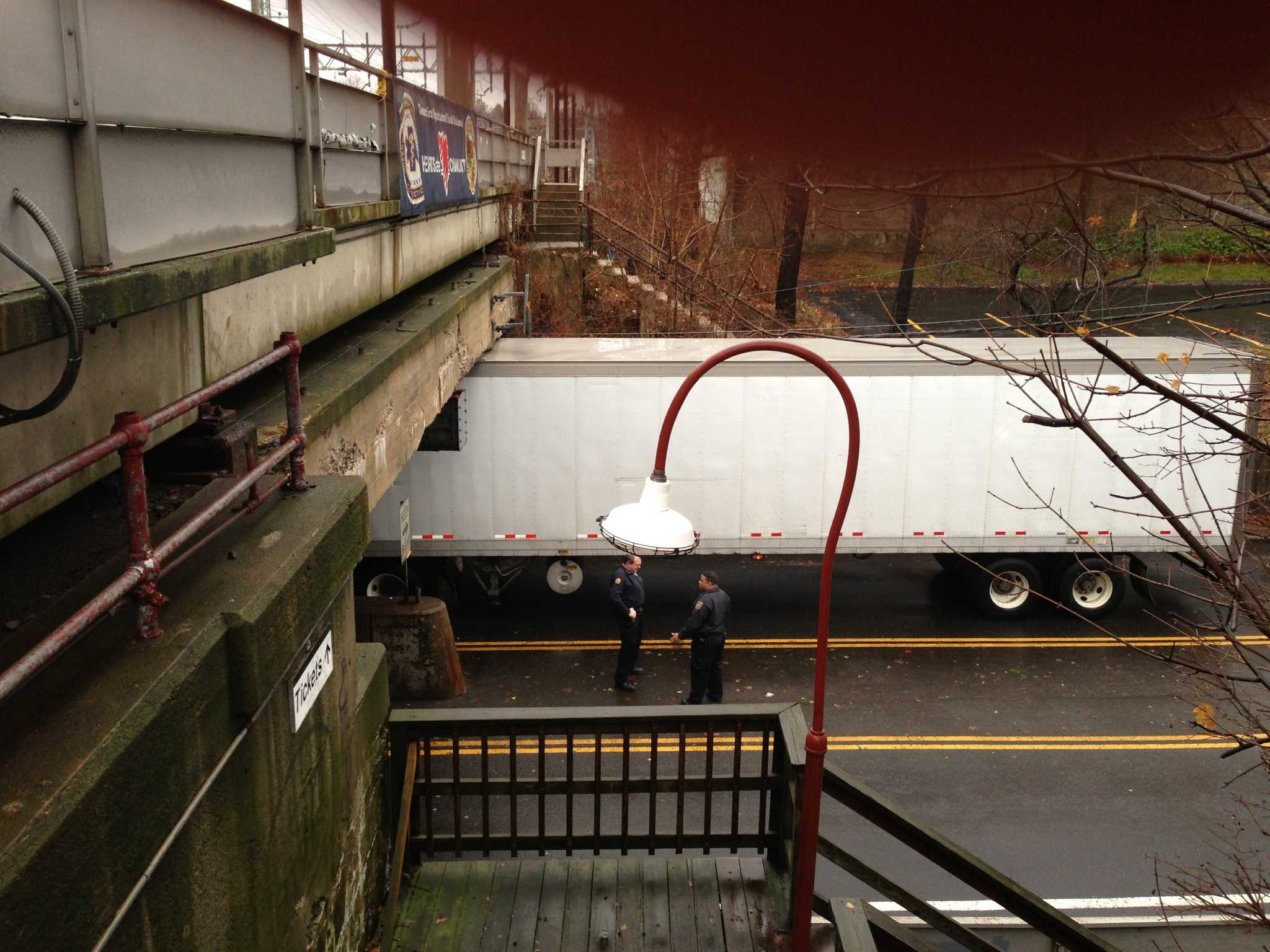 Truck gets stuck under bridge
