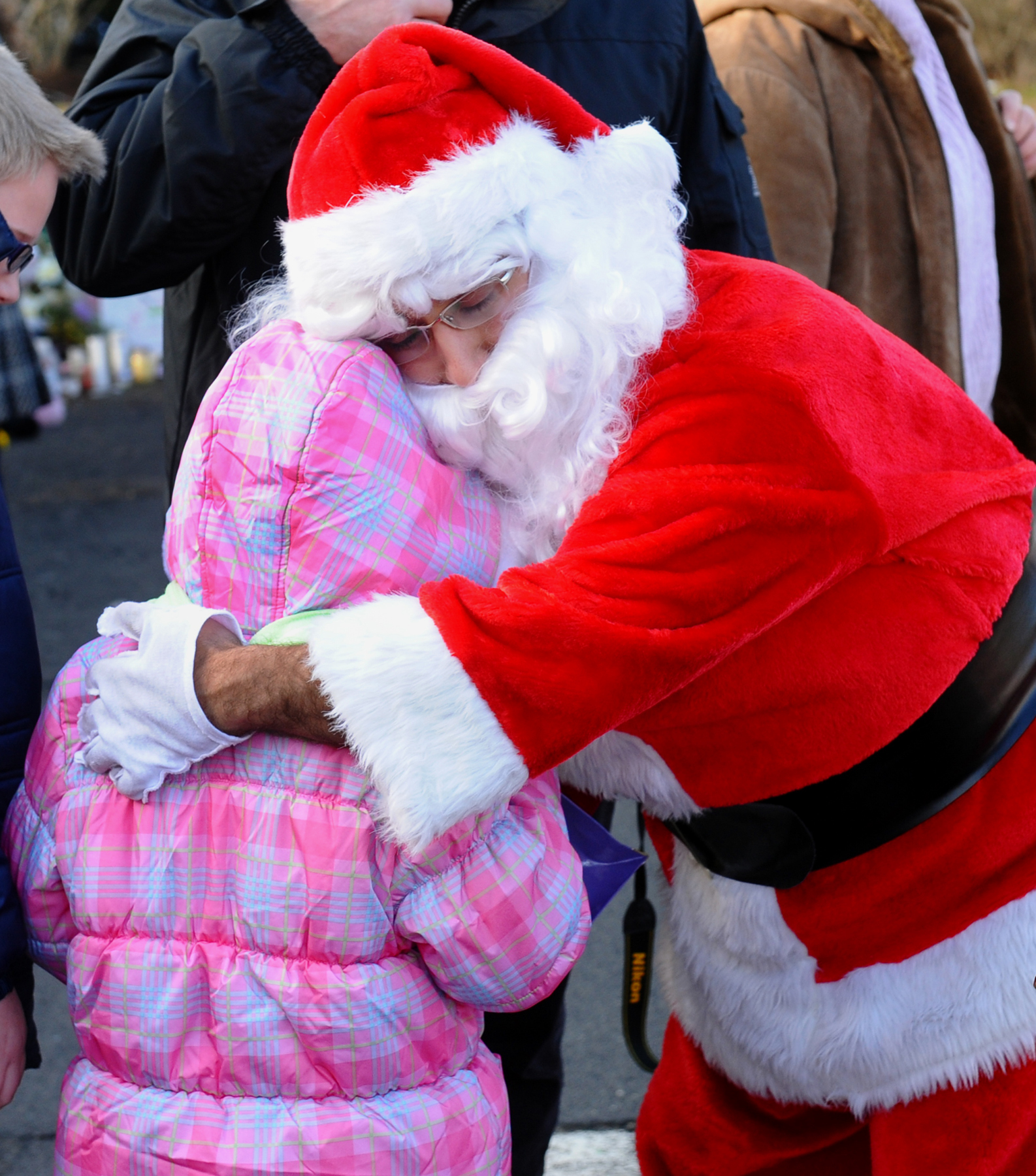 Santa brings gifts, and condolences, to Newtown