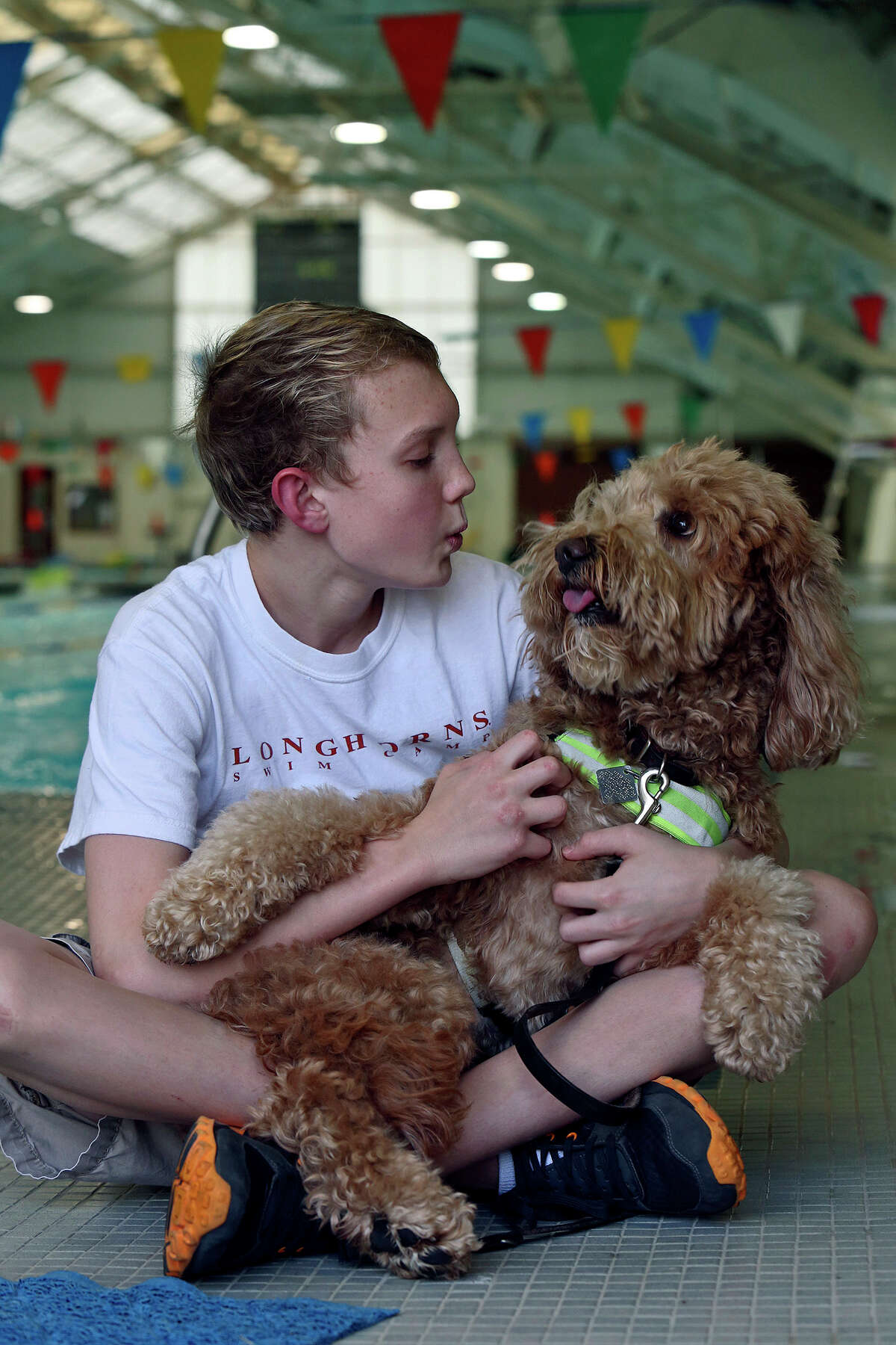 Teen swimmer always brings a four-footed life preserver