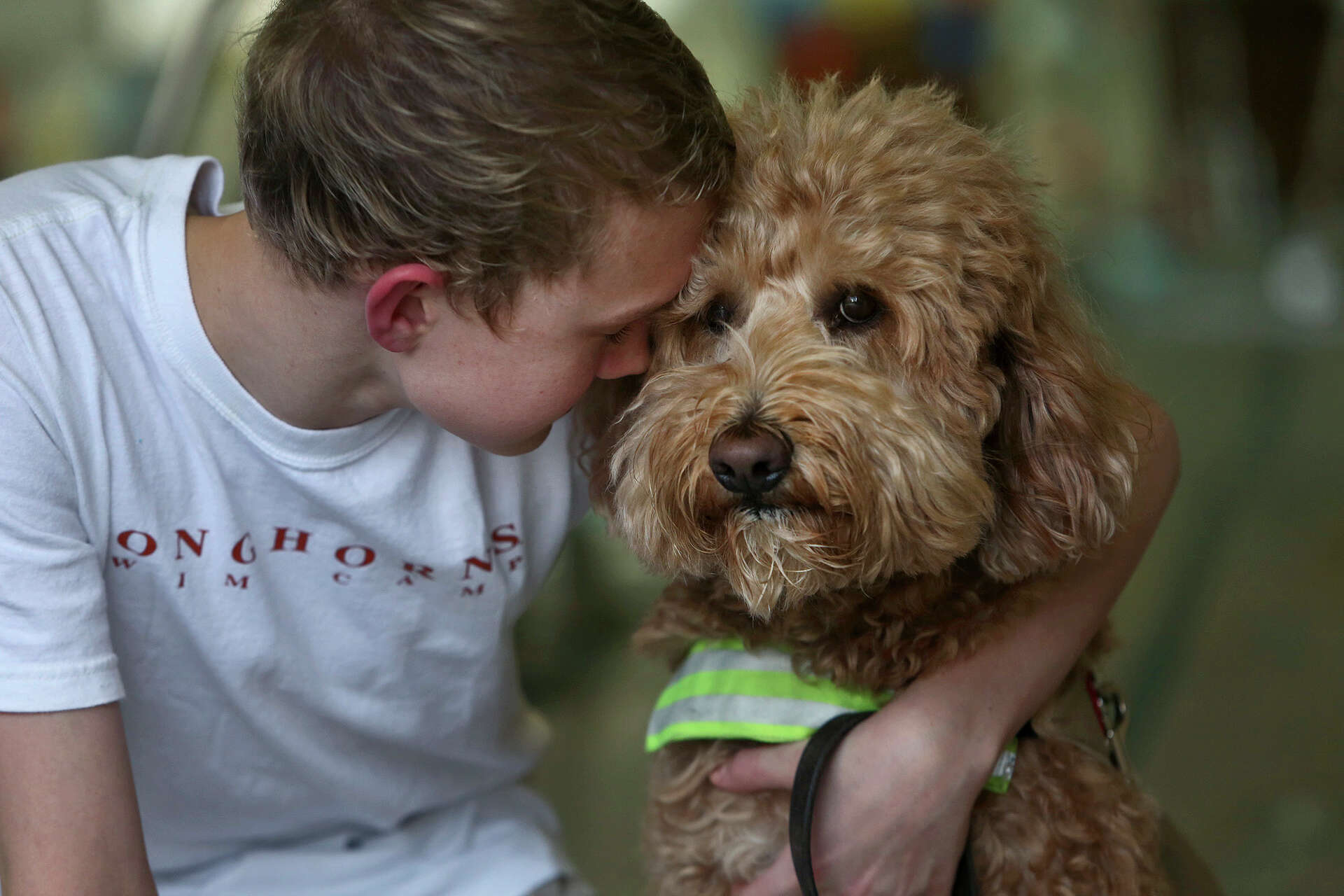 Teen swimmer always brings a four-footed life preserver