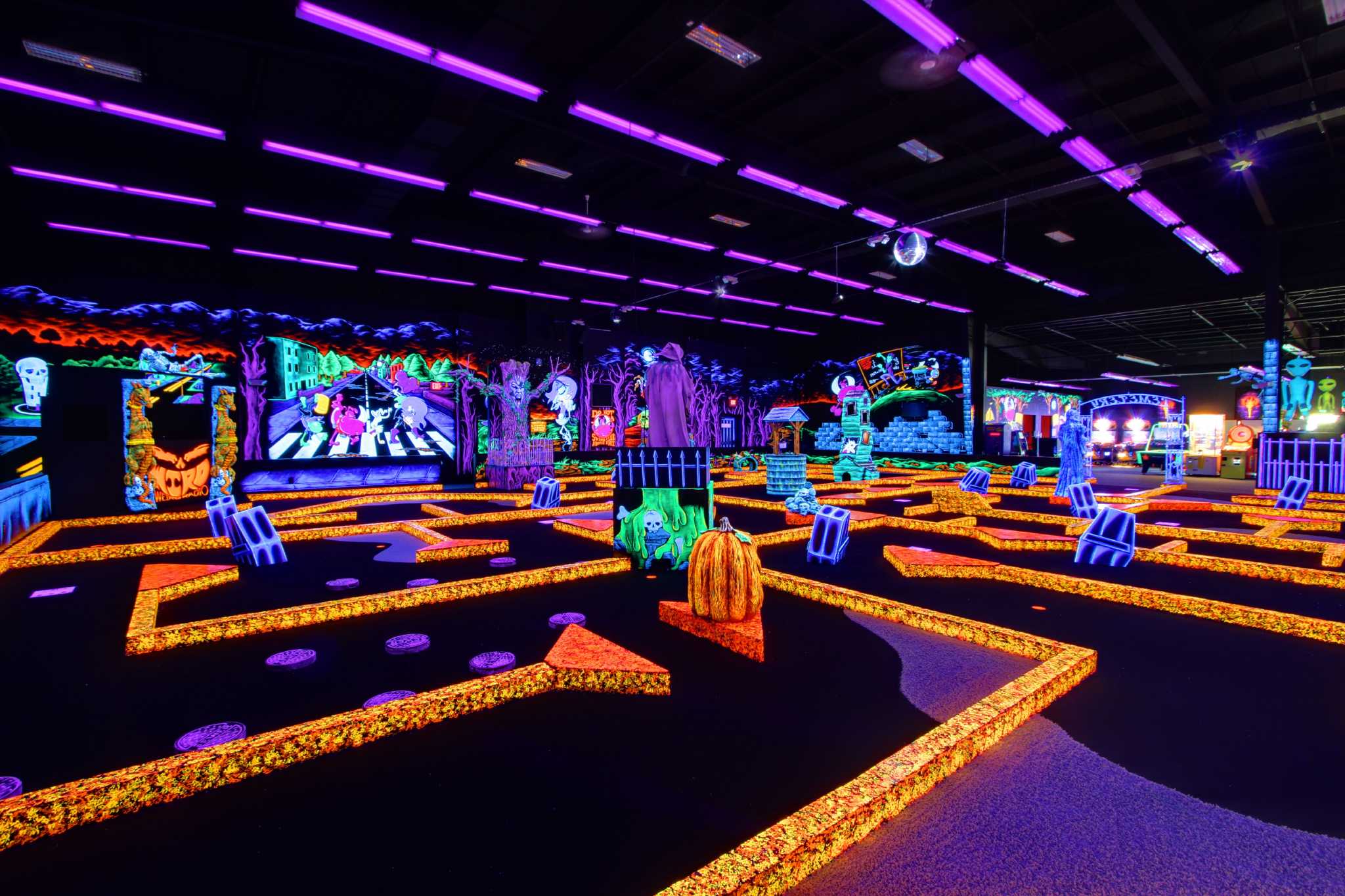 Neon lights, animatronic creatures part of fun at Monster Mini Golf ...