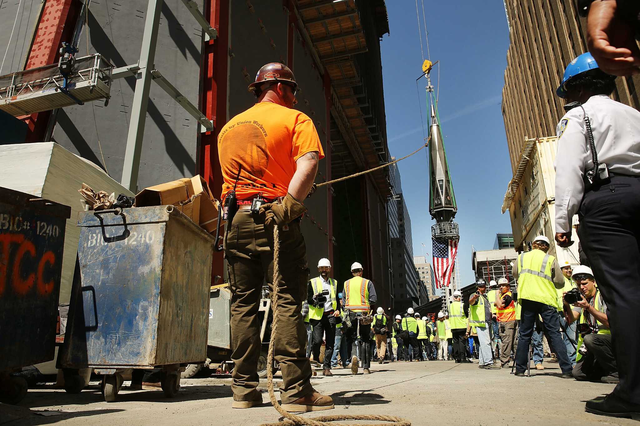 U.S. flag-covered spire hoisted to NY's WTC roof