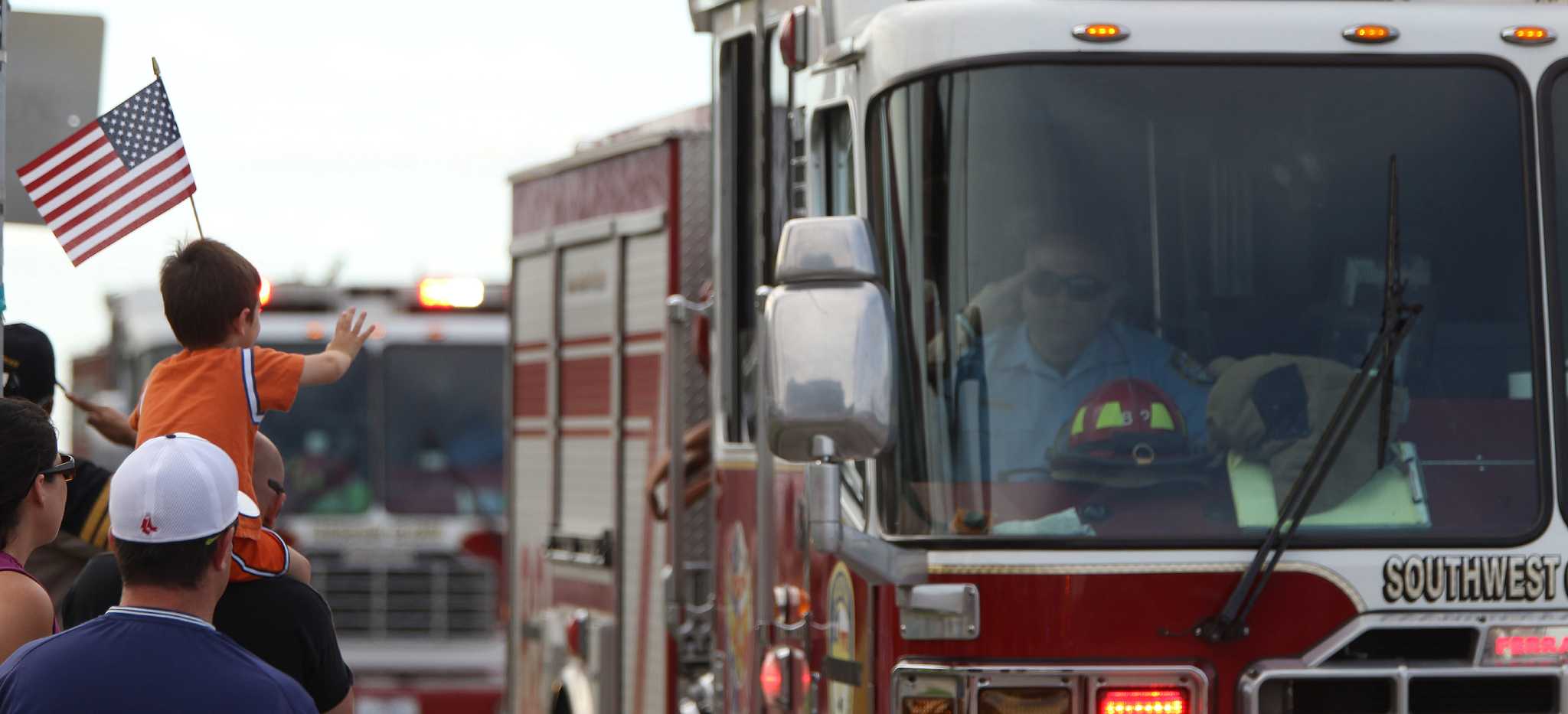 Somber procession forms wall of honor for fallen firefighters