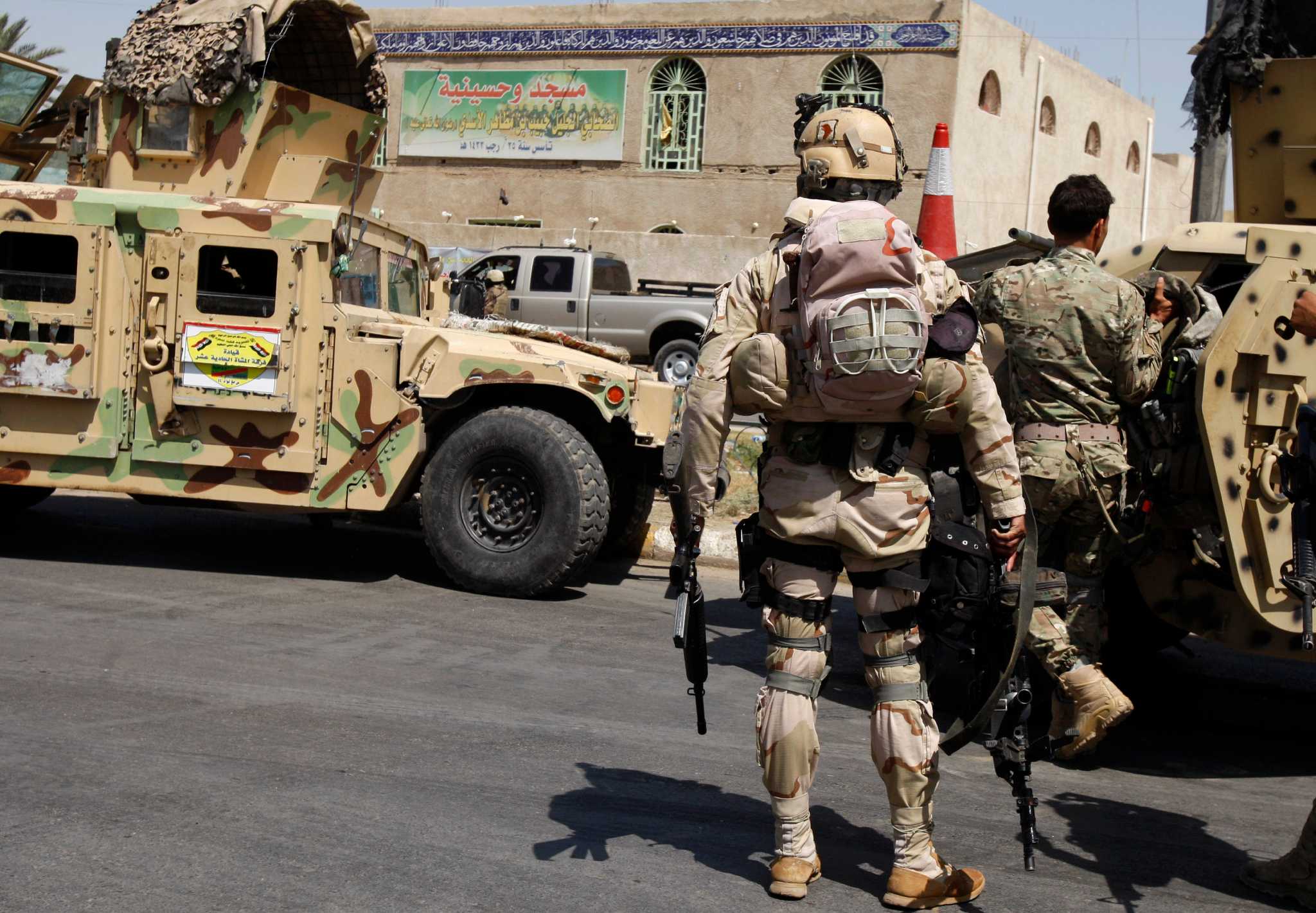 Iraqi suicide bombers hit Baghdad mosque, kill 34