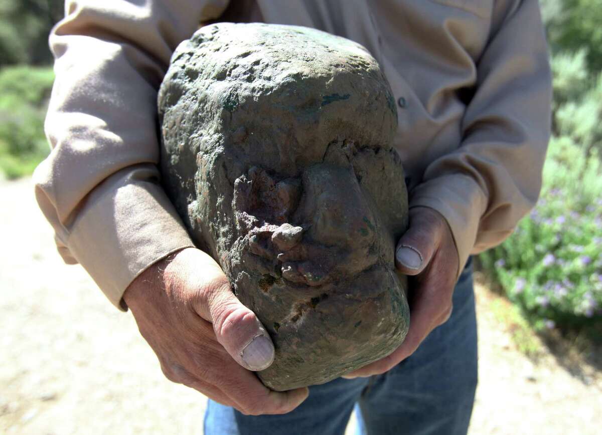 World news photos: Fossilized head of bigfoot? Branded for animals and more