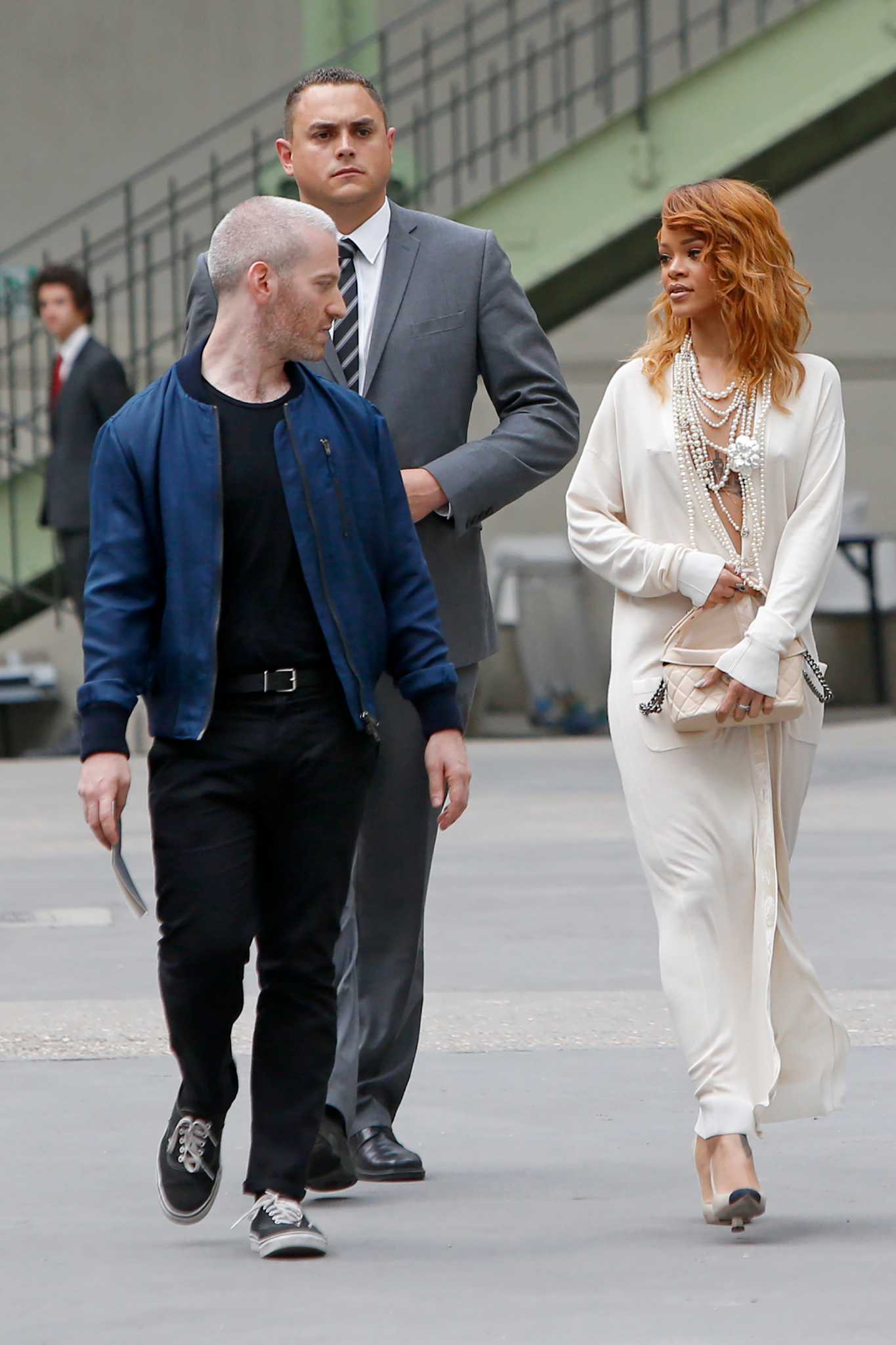 Rihanna struggles with risqué dress at fashion show