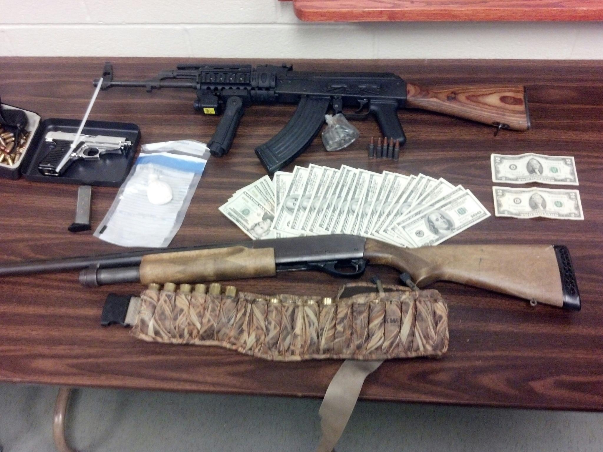 Raid Finds Drugs Guns Cash