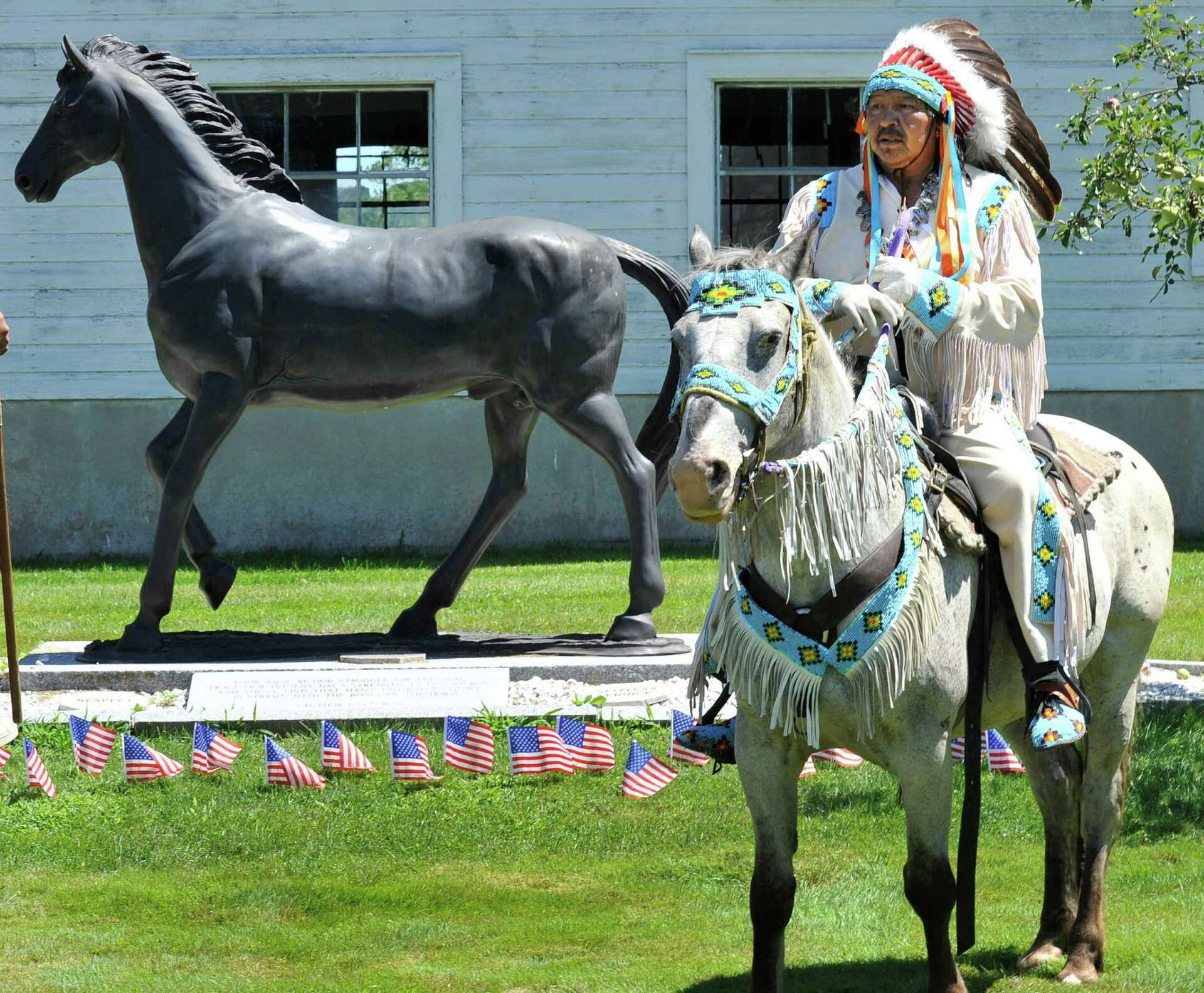 Sioux ride with horse guard in Newtown