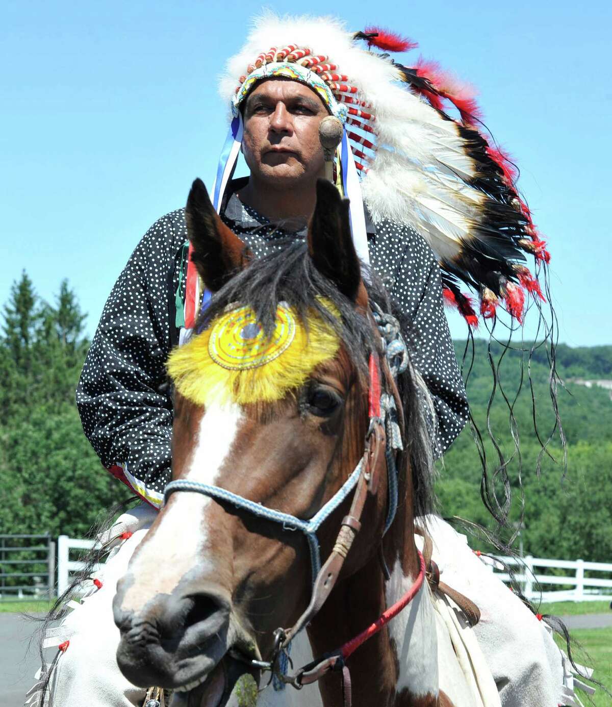 Sioux ride with horse guard in Newtown