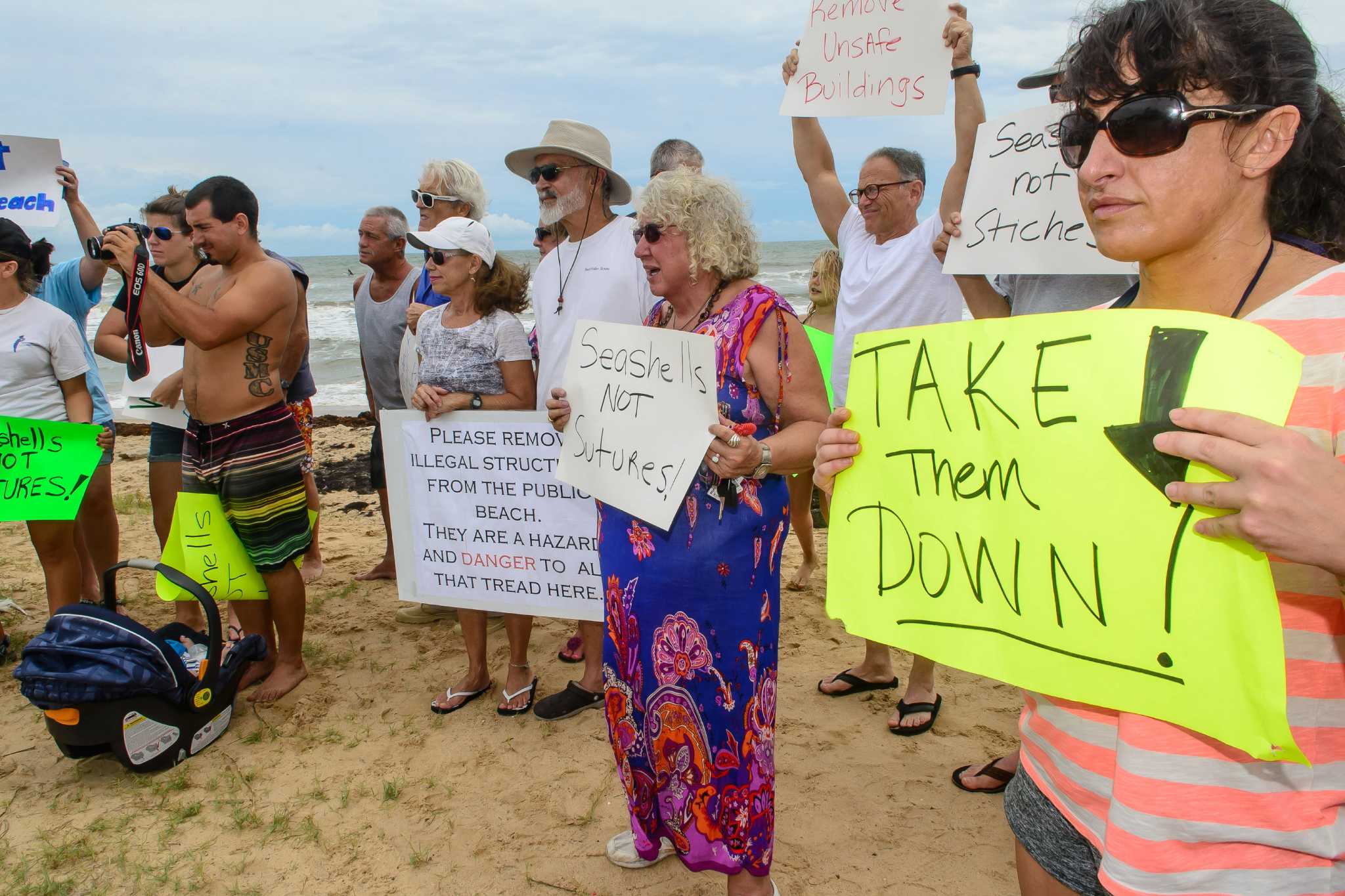 Battered beach houses focus of beach fight