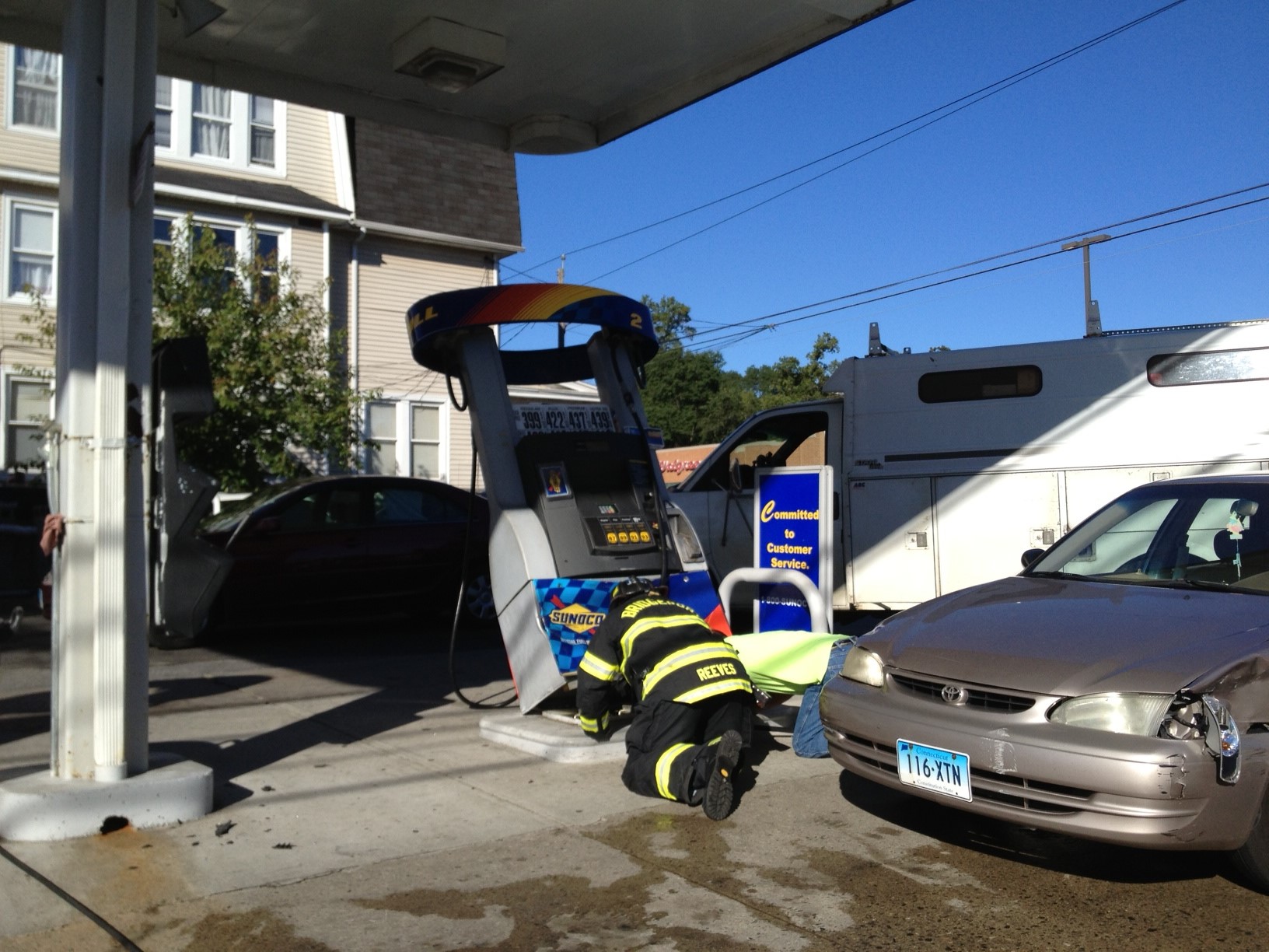 Car strikes gas pump; spill contained
