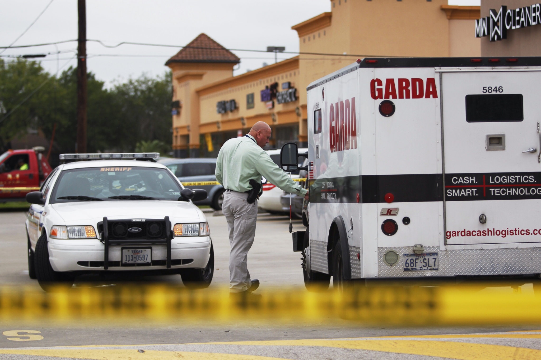 Scared witnesses watch as guard fires on masked men at Spring bank