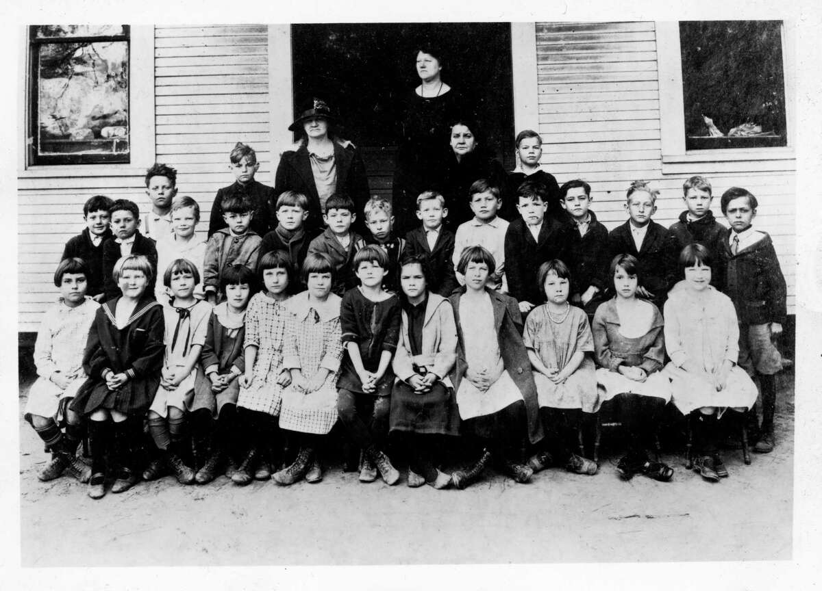 Historic little red schoolhouse facing final bell