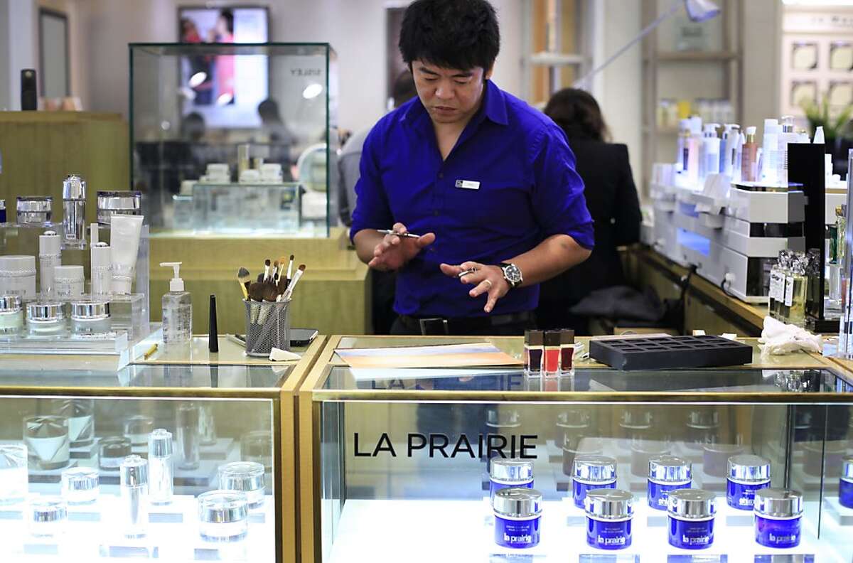Makeup artist creates scenes on the cosmetics floor