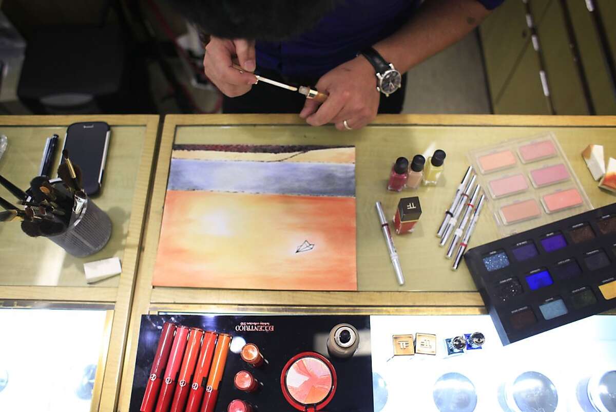 Makeup artist creates scenes on the cosmetics floor