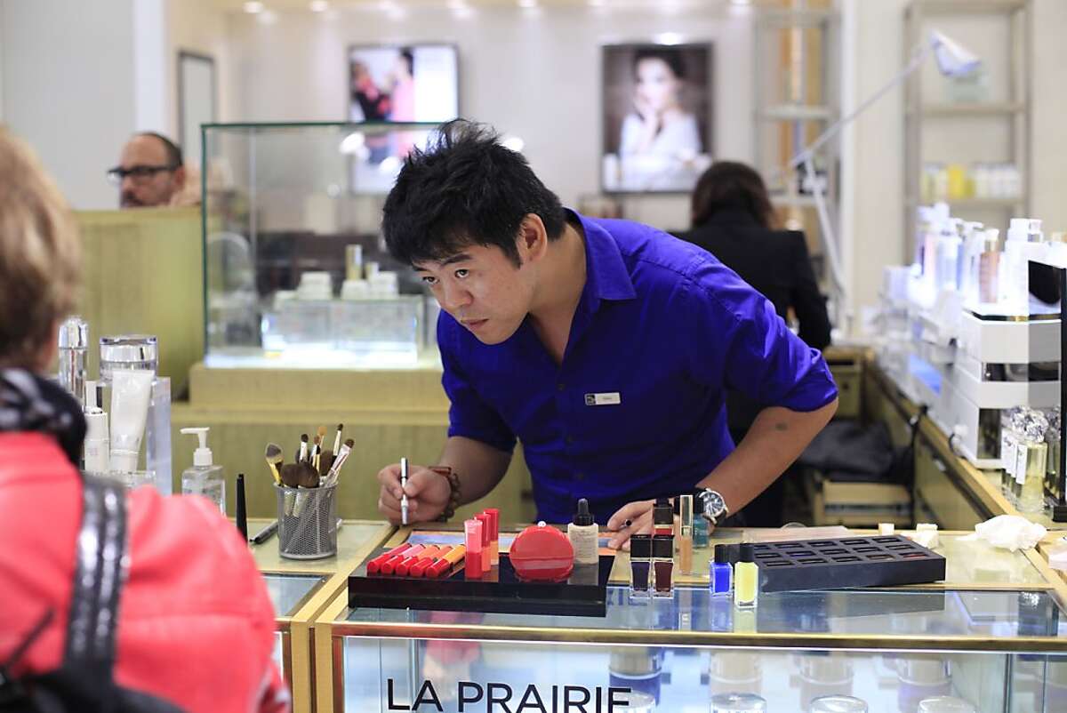 Makeup artist creates scenes on the cosmetics floor