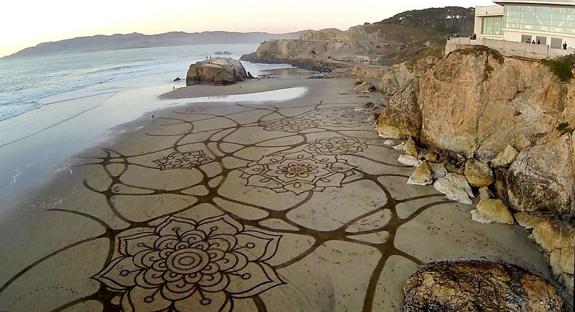 Beach artist's works are gone with the next tide