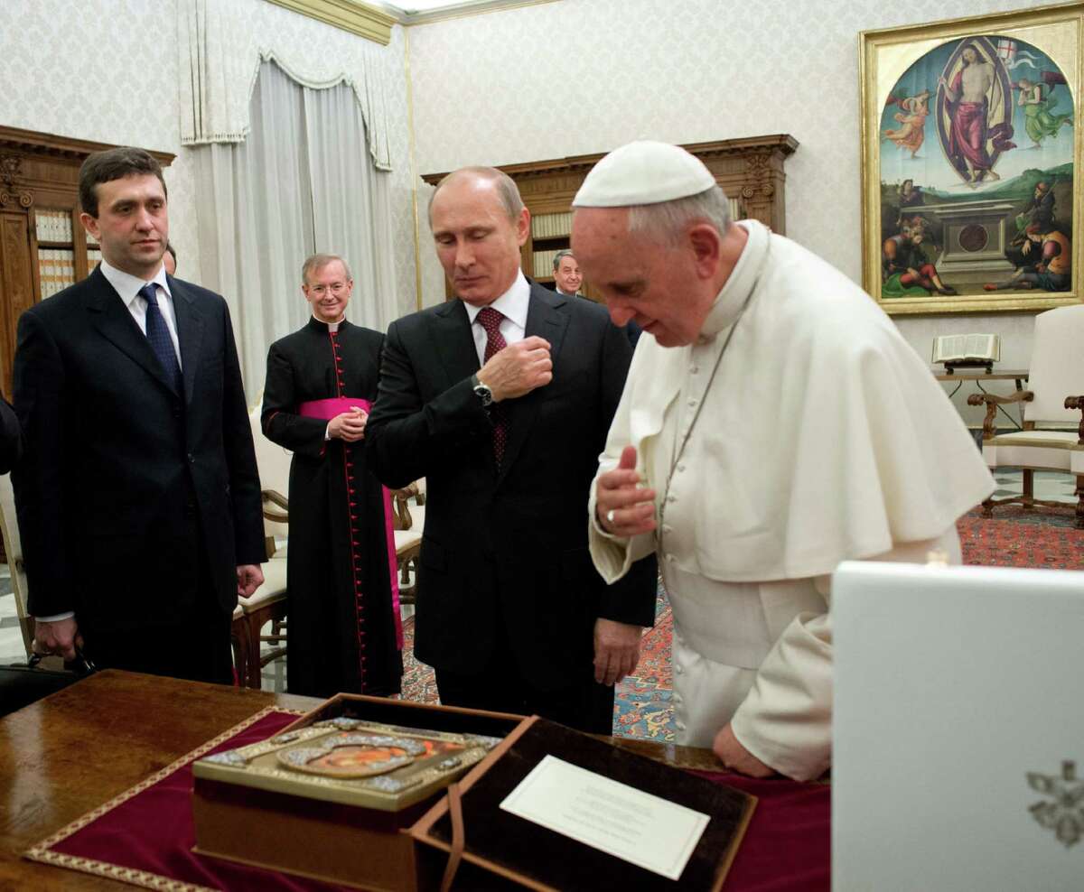 Putin kisses icon, visits the pope