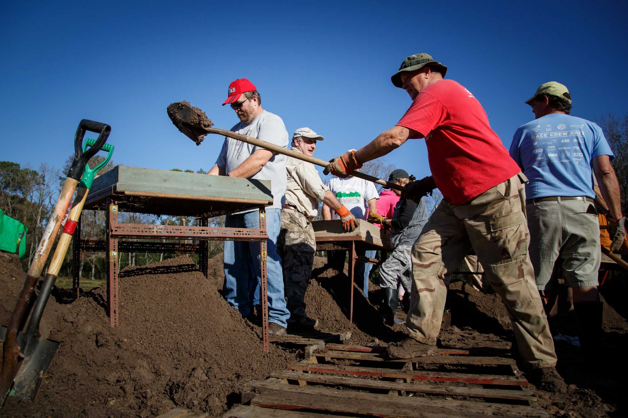 Amateur archaeologists sift through dirt from construction site