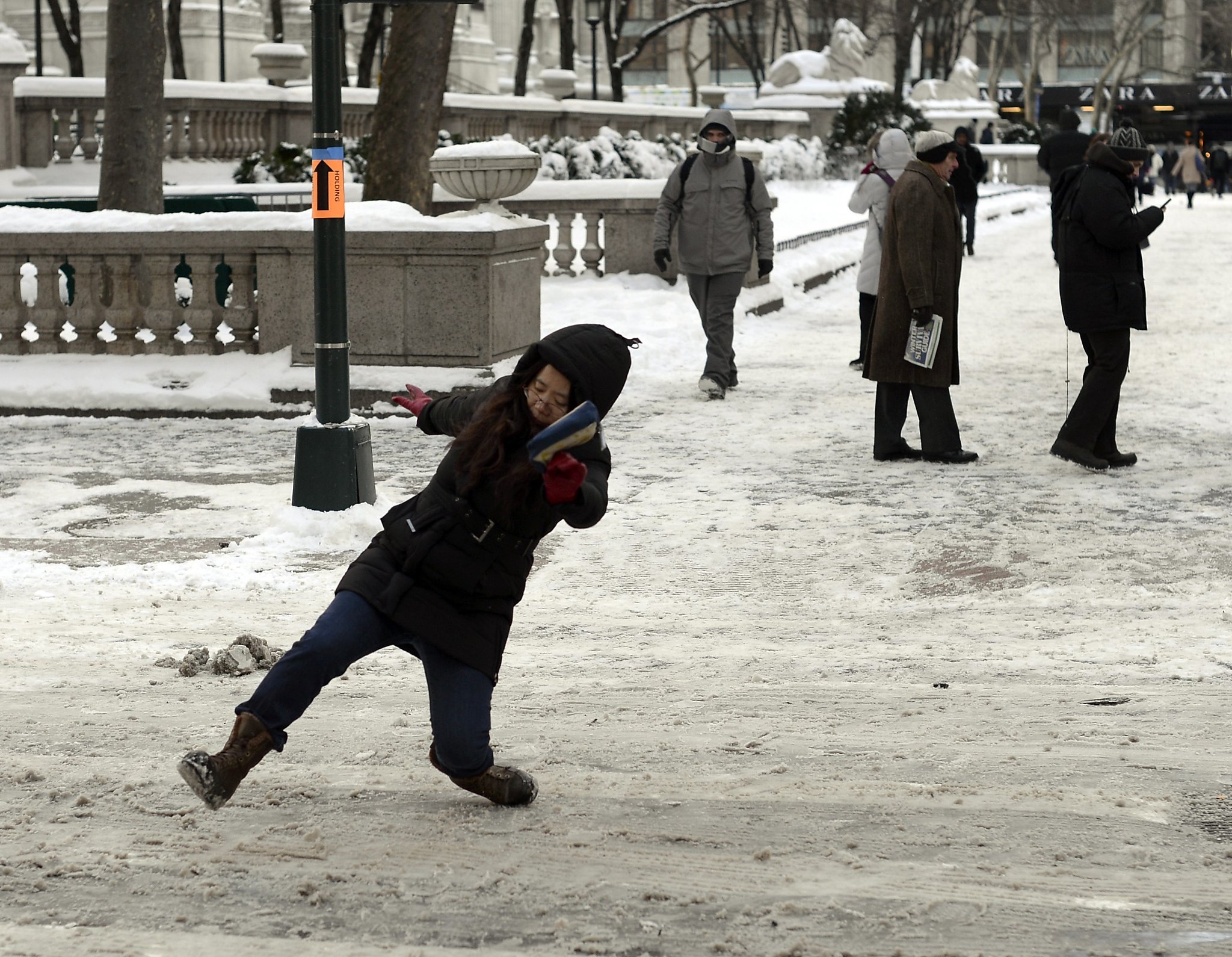 Whoops! New Yorkers slip on ice, fall on their butts