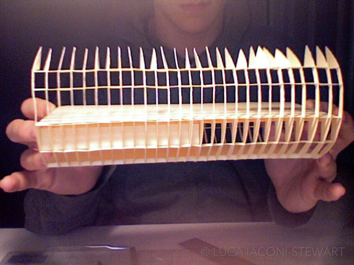 Man building Boeing 777 out of manila folders