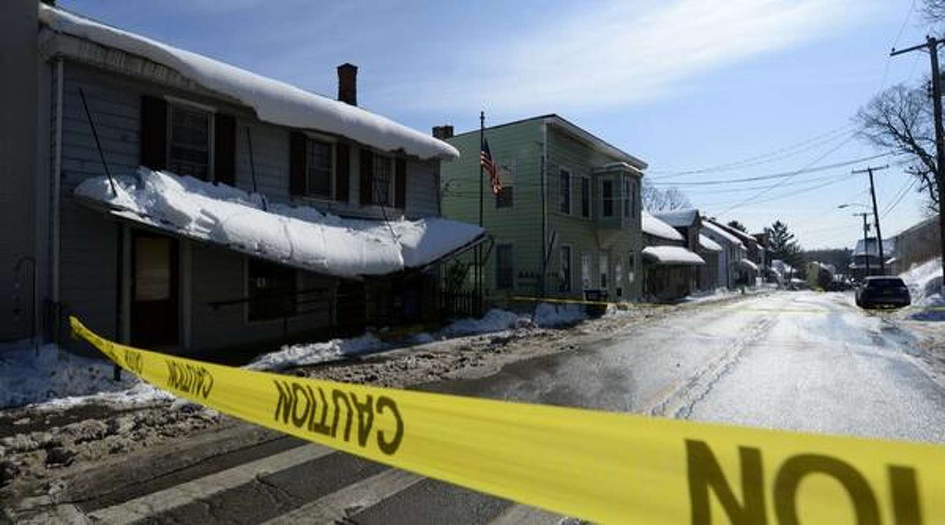Snow partially collapsing post office canopy