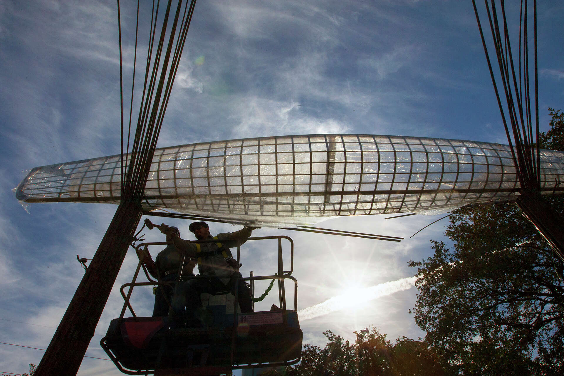 Stainless steel canoe appears in the trees along Buffalo Bayou