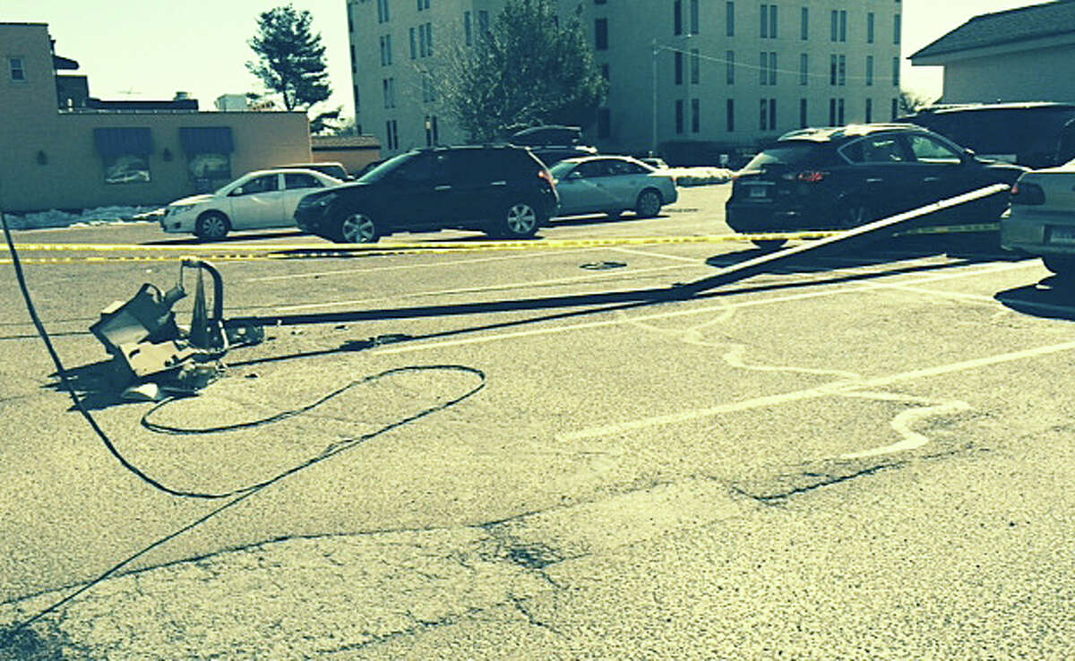 Light pole tumbles down in Post Road lot, narrowly missing vehicles