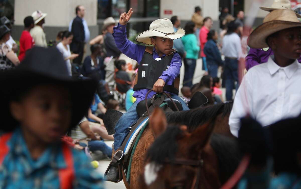 Cowboys trek through downtown to Rodeo kickoff
