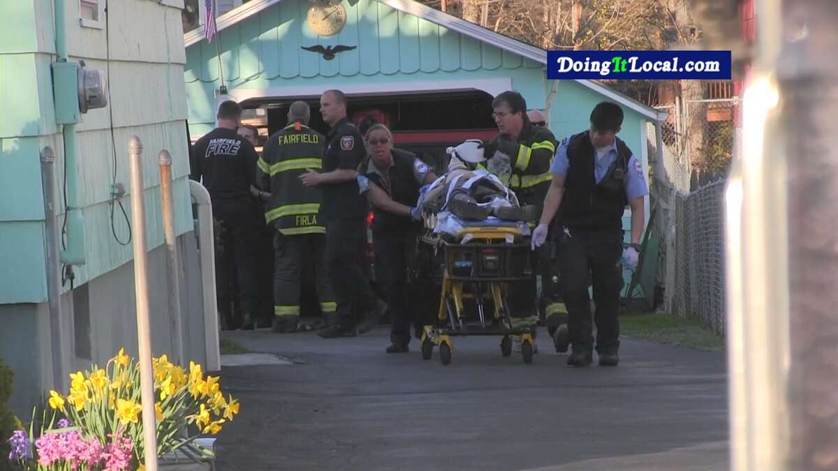 Man pinned between truck, garage wall