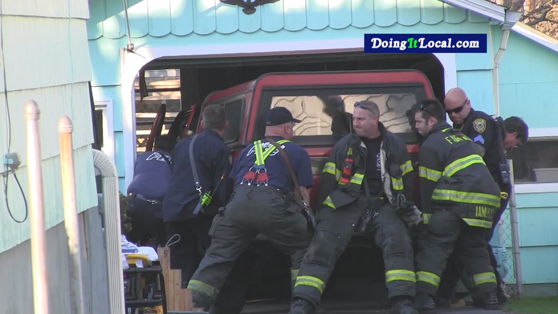 Man pinned between truck, garage wall