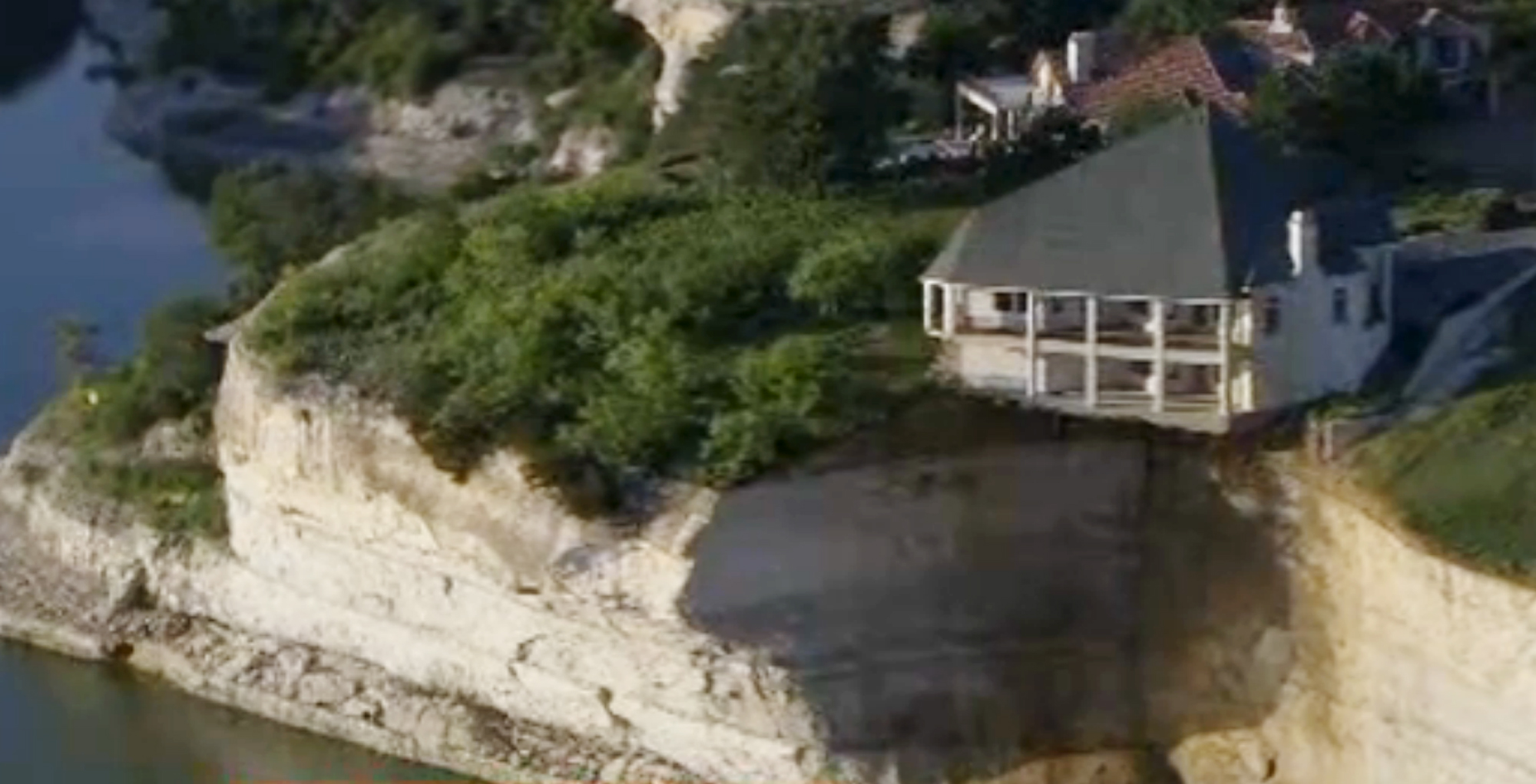 Home sliding off cliff
