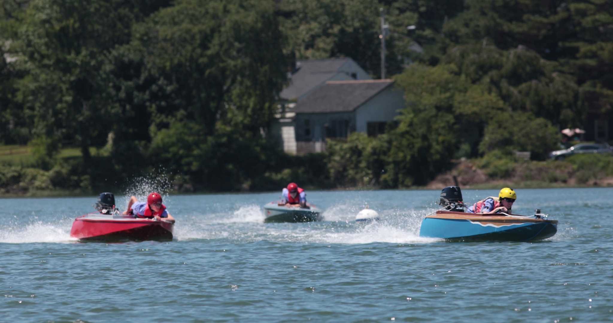 Aquaculture students race boats they made