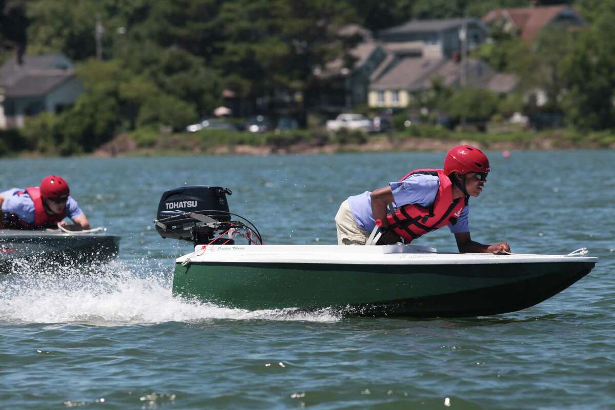 Aquaculture students race boats they made