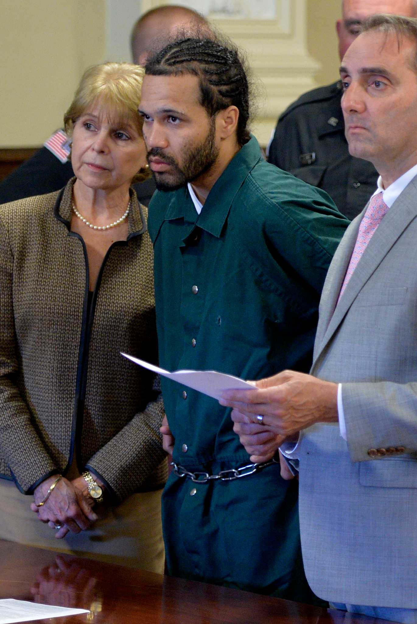 Under family's watchful eyes, murder suspect arraigned
