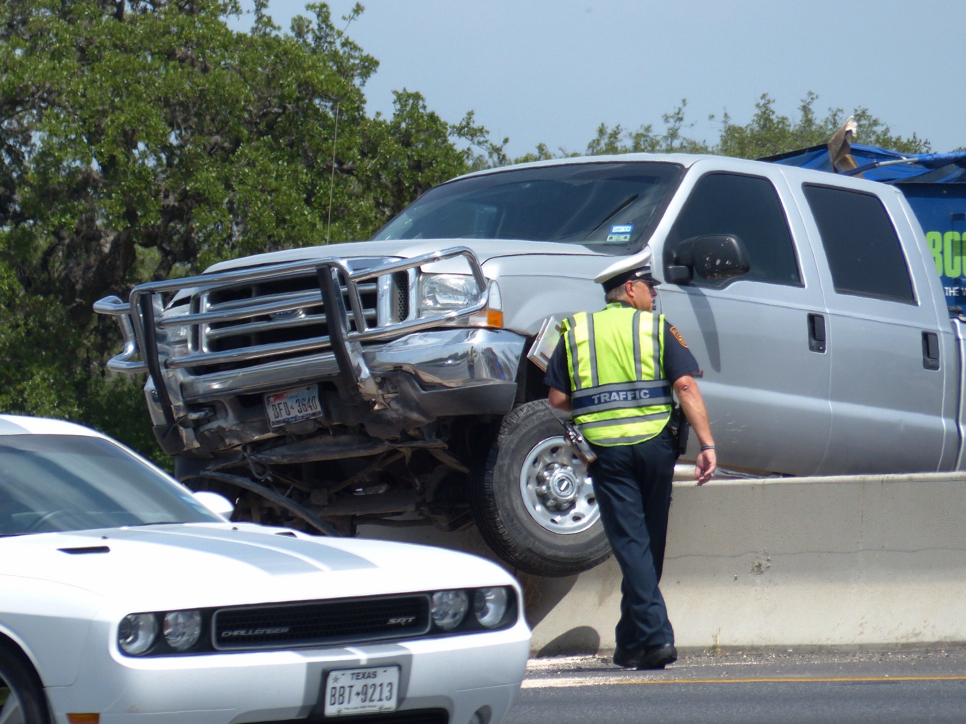 Truck straddling highway divider backing up traffic on Loop 1604