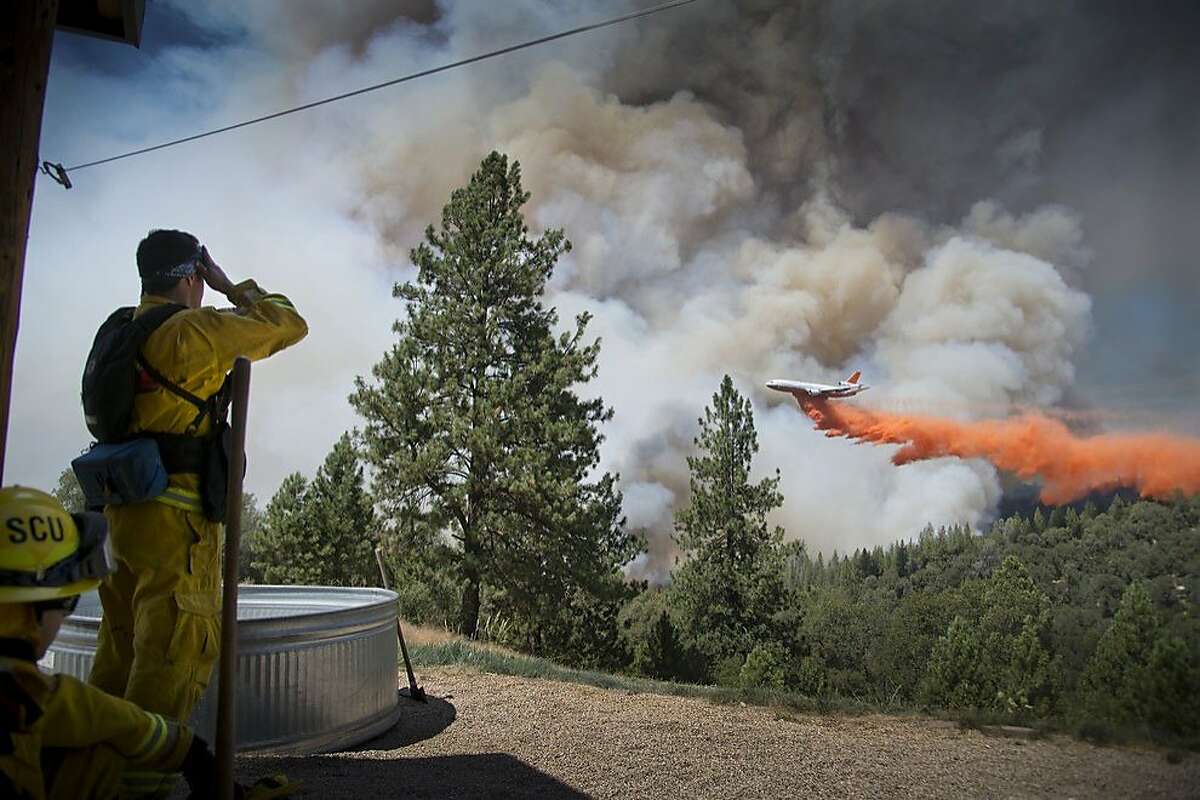 Sierra foothills fire burns 13 homes; Yosemite fire grows