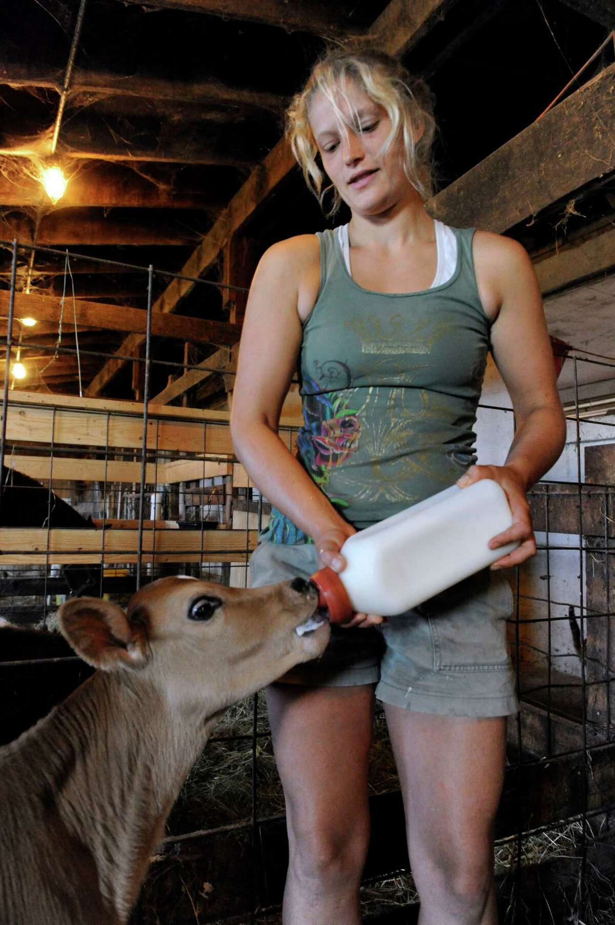 Young farmer cares for cows and crops