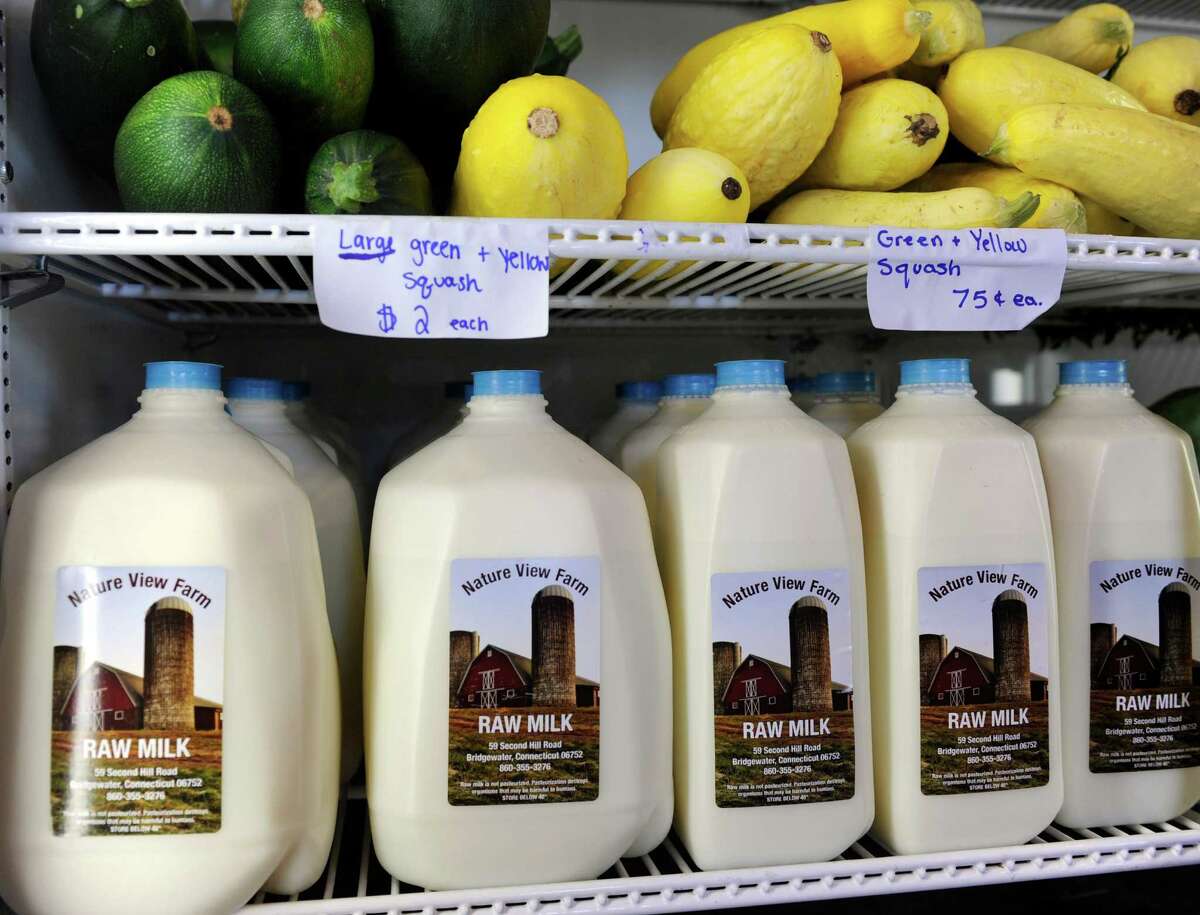 Young farmer cares for cows and crops