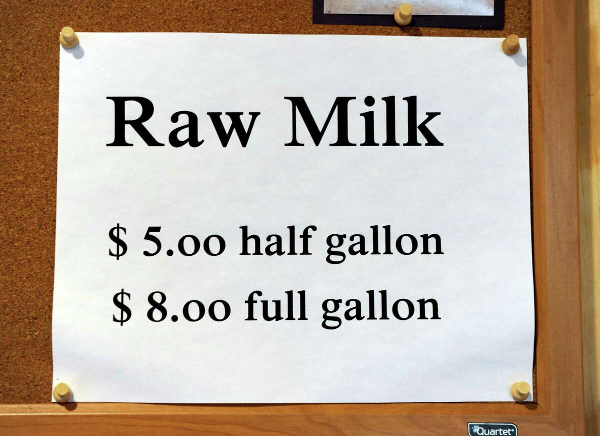 Young farmer cares for cows and crops