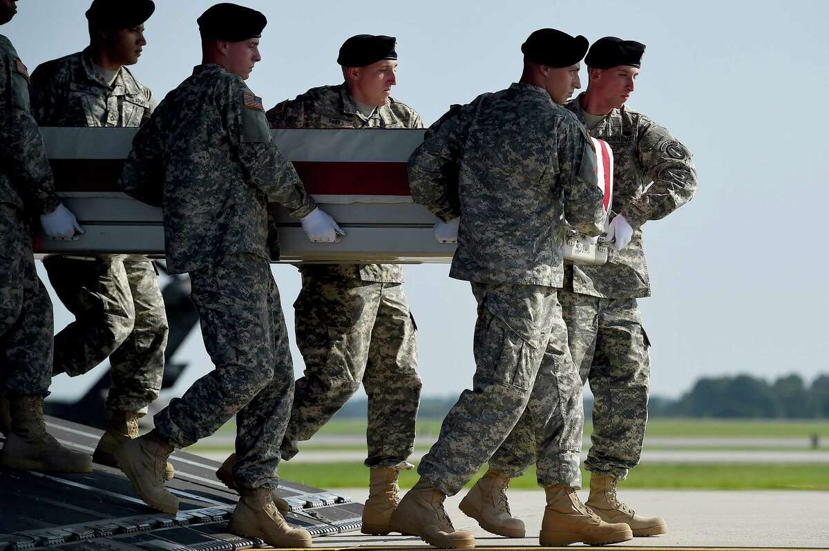 General's remains land at Dover base